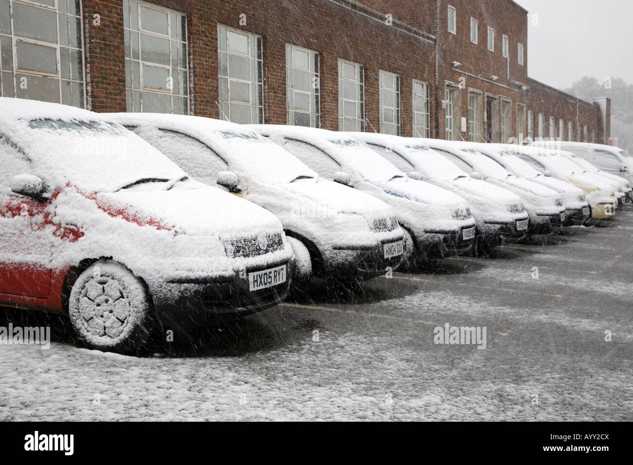 Line of snow covered parked cars Stock Photo - Alamy