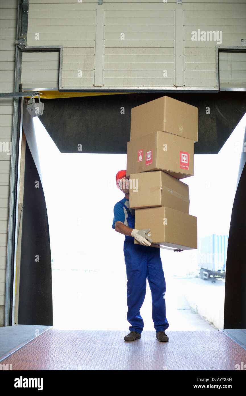 Man carrying a stack of boxes Stock Photo - Alamy