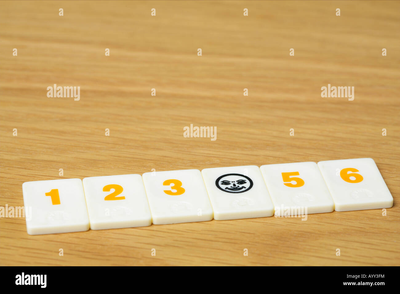 Tile with smiley between tiles with numbers Stock Photo - Alamy