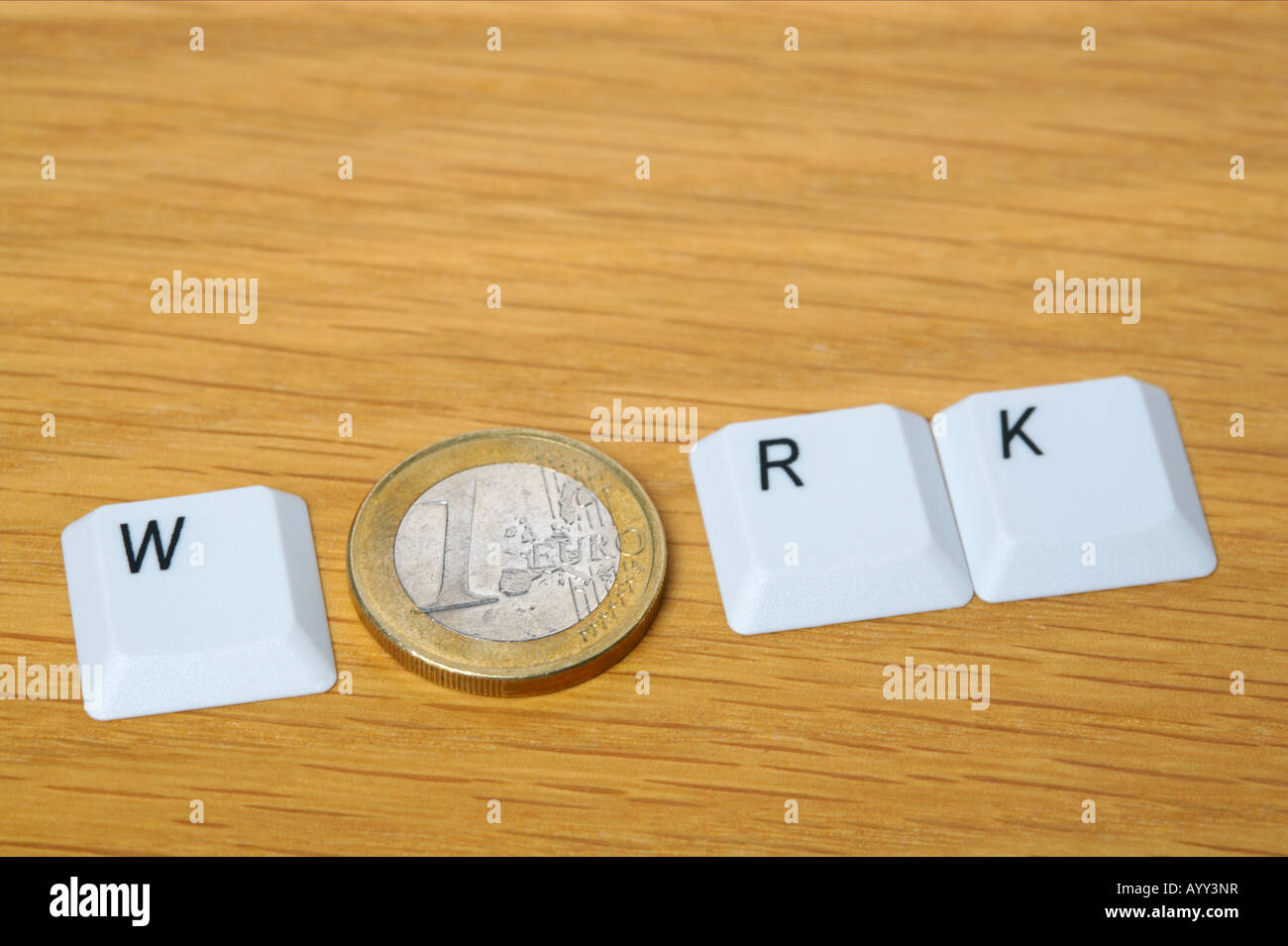 One Euro coin and keys of a computer keyboard writing the single word ...