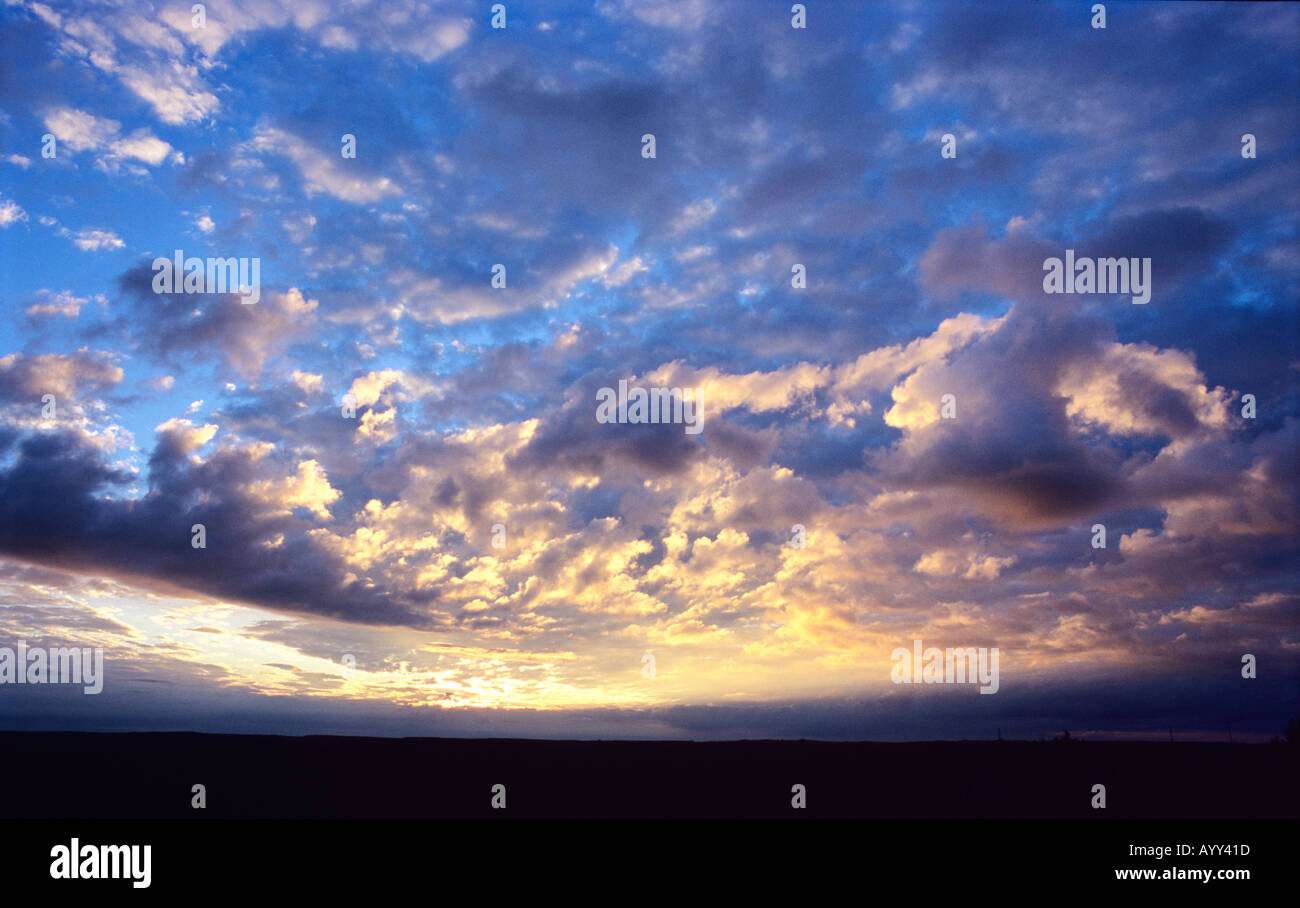 Sinking below earth s horizon sun paints evening clouds Theodore ...
