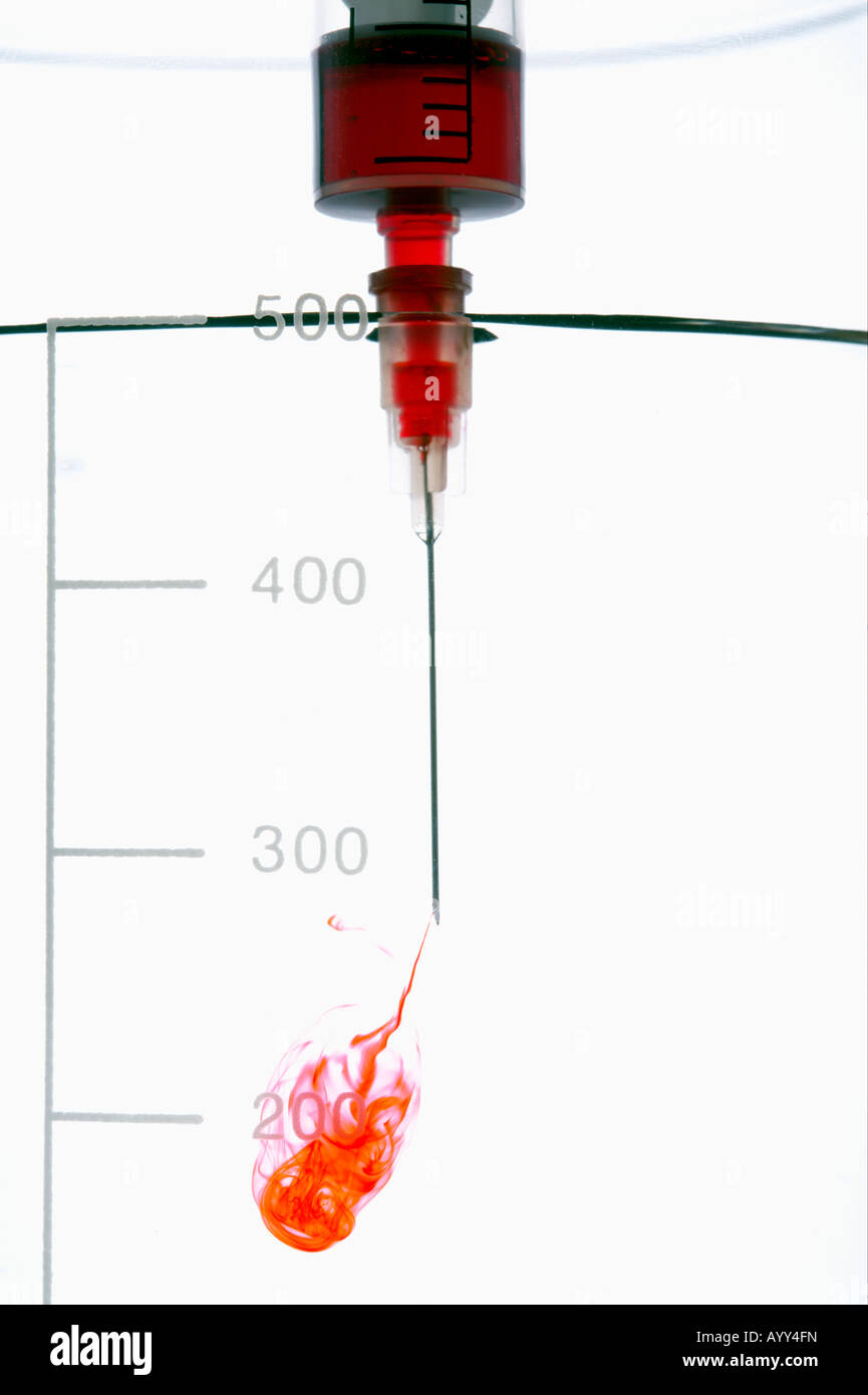 Injection of red liquid into water Stock Photo - Alamy