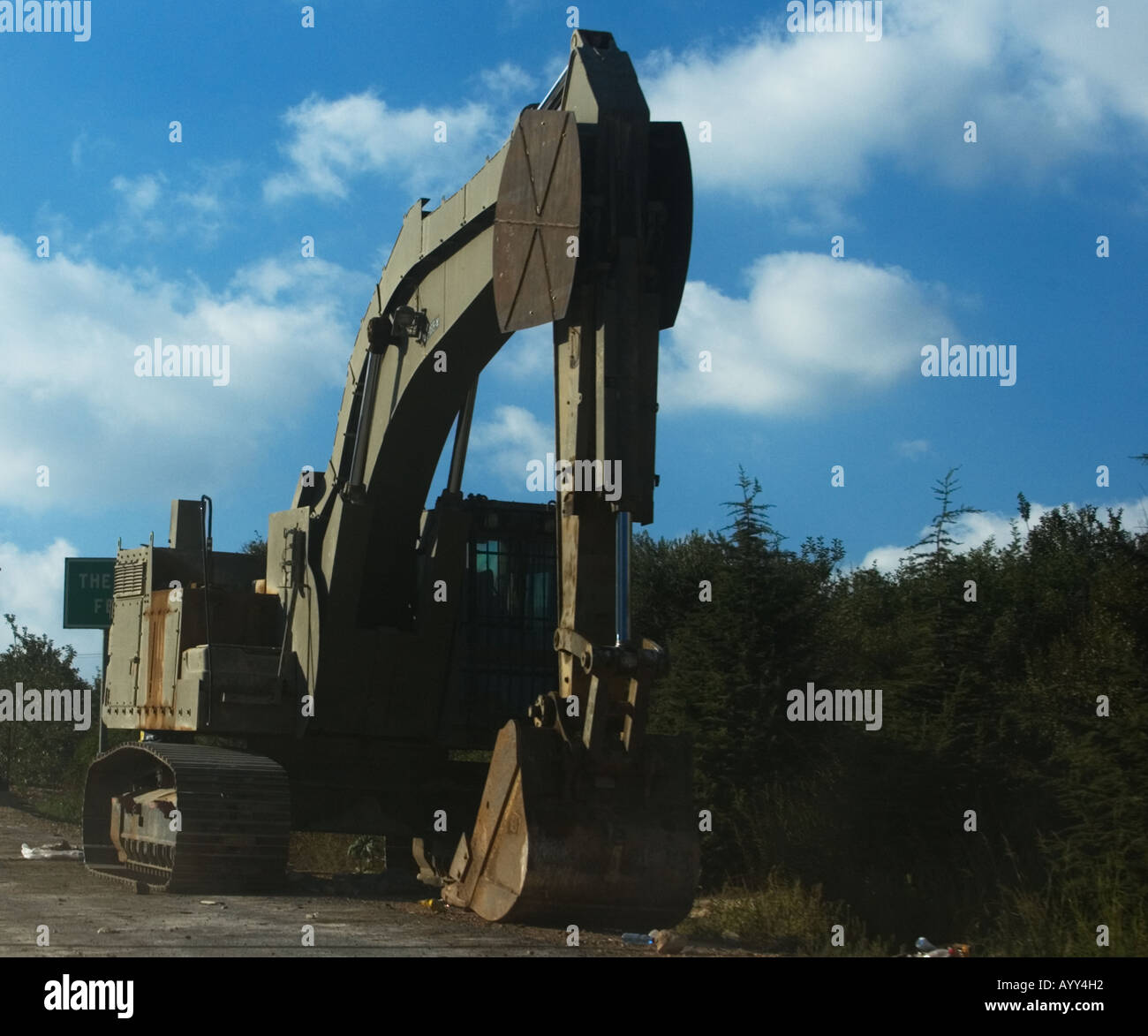 Armoured excavator on israel Lebanon border with blue sky behind and ...