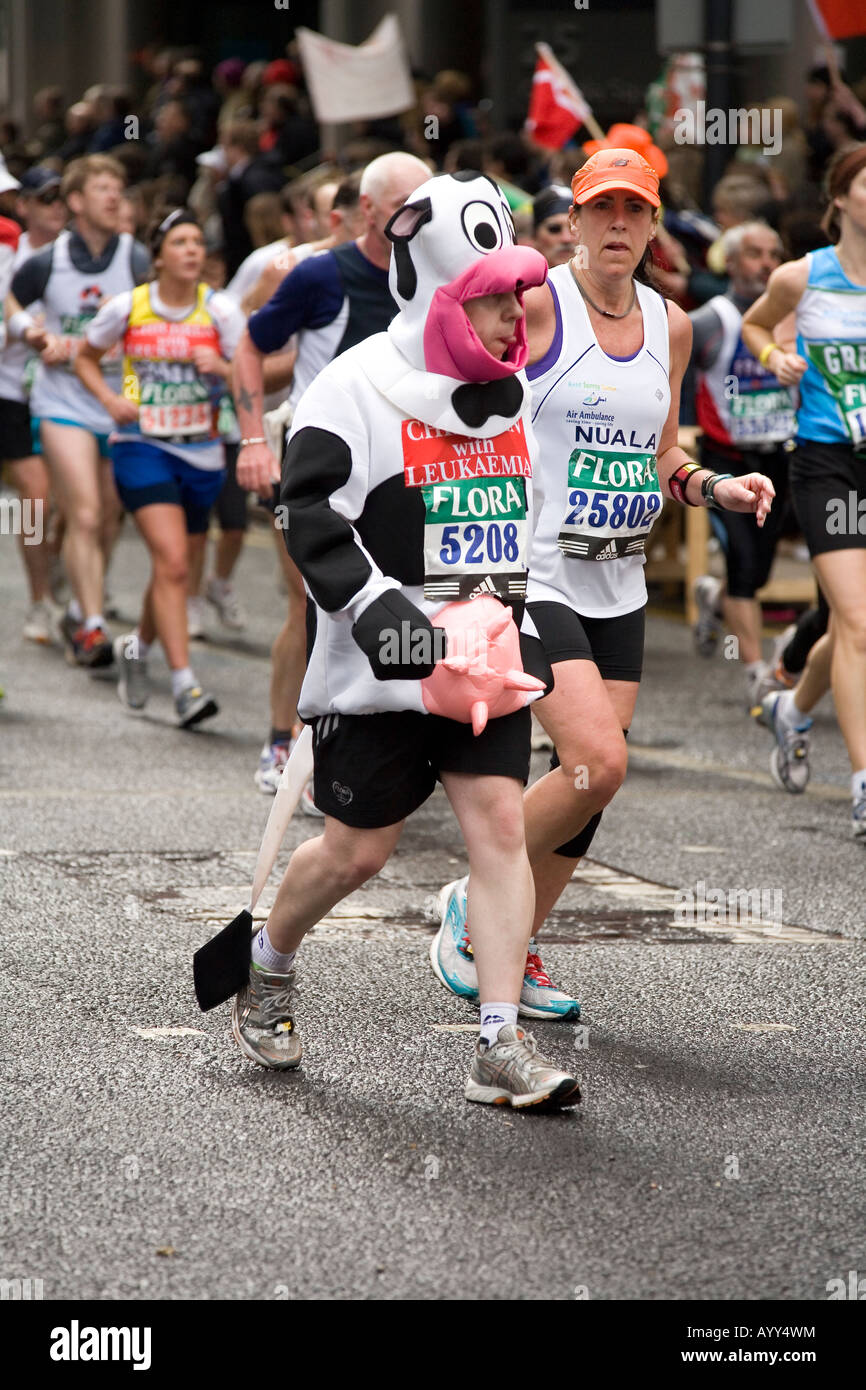 Fancy dress runners a man dressed as a cow at the London Flora Marathon ...