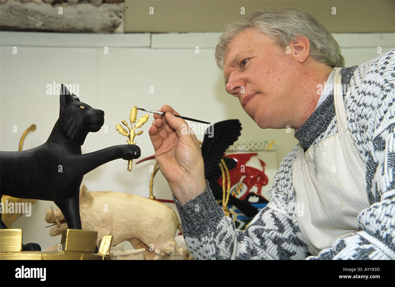 Ian Brennan the sculptor painting part of a Crown , which is going into ...