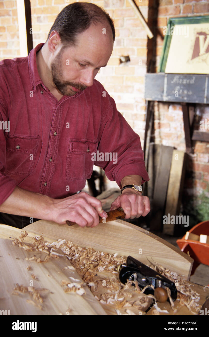 a craftsman making a traditional Wooden Wheelbarrow made by hand Stock ...