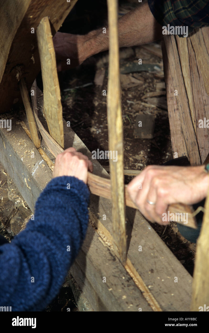 Threading cut and split timber to make the wattle frame in a Wattle and ...