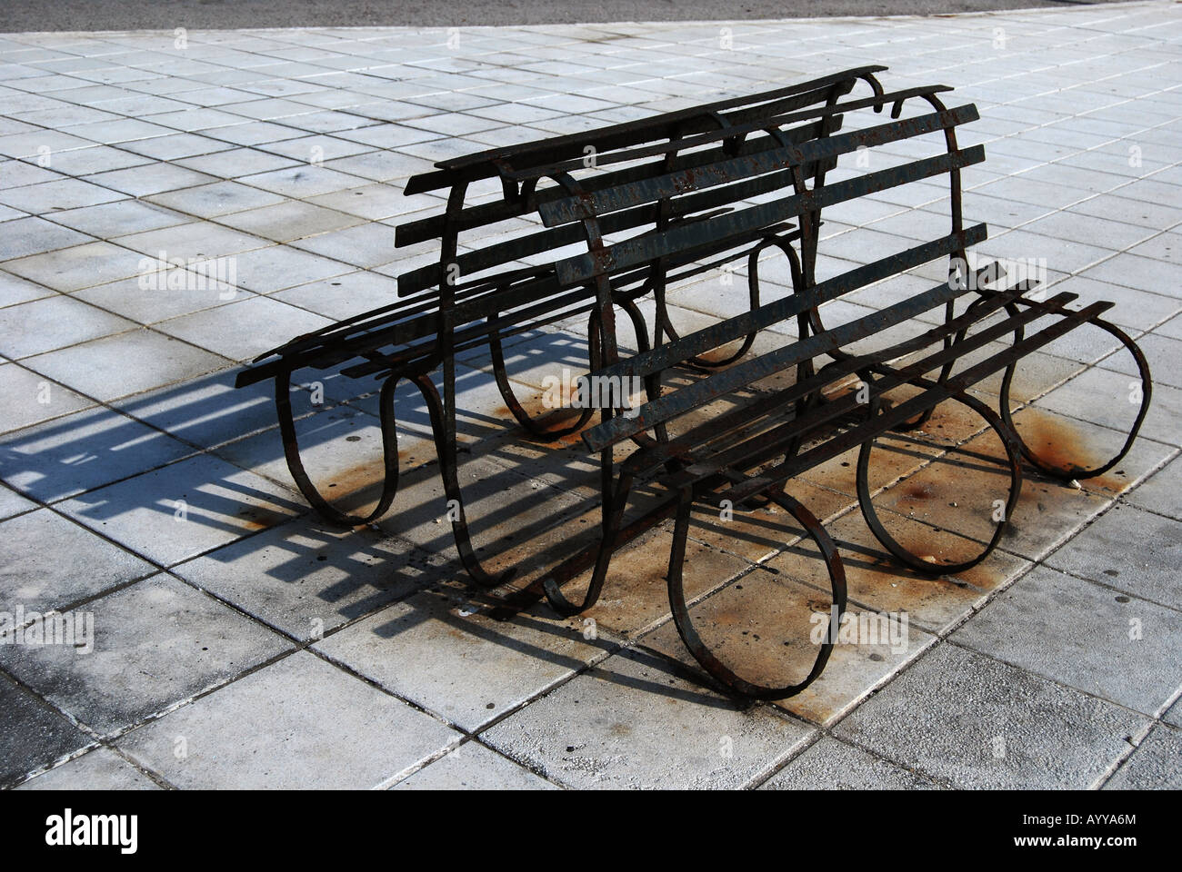 A rusty double iron bench Stock Photo - Alamy