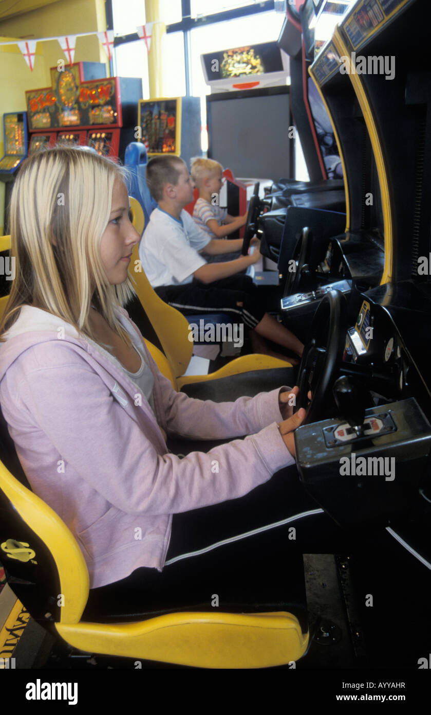 teenage girl in amusement arcade on driving machine Stock Photo - Alamy