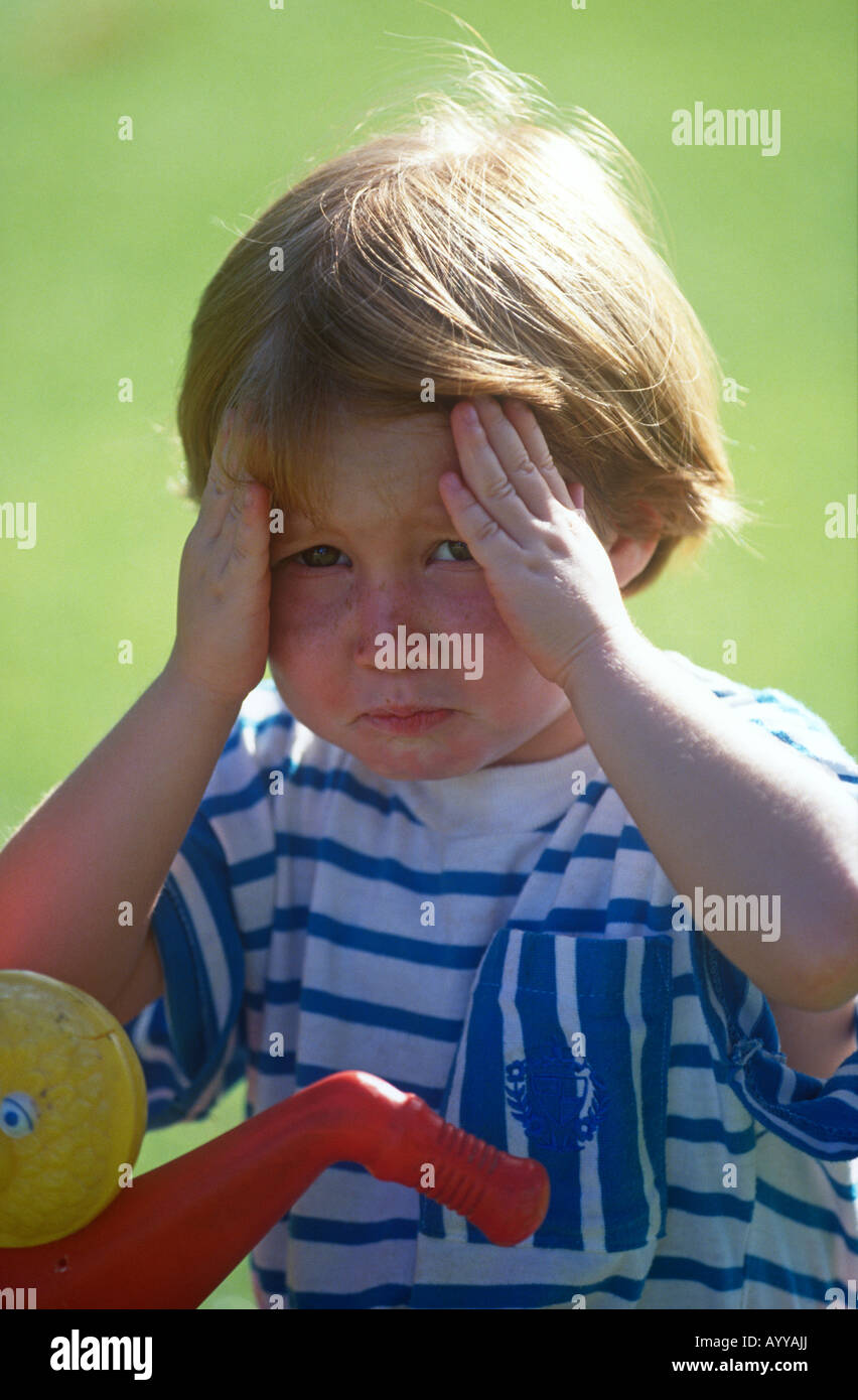 Sad, pouting and crying girl holding her head in her hands Stock Photo ...