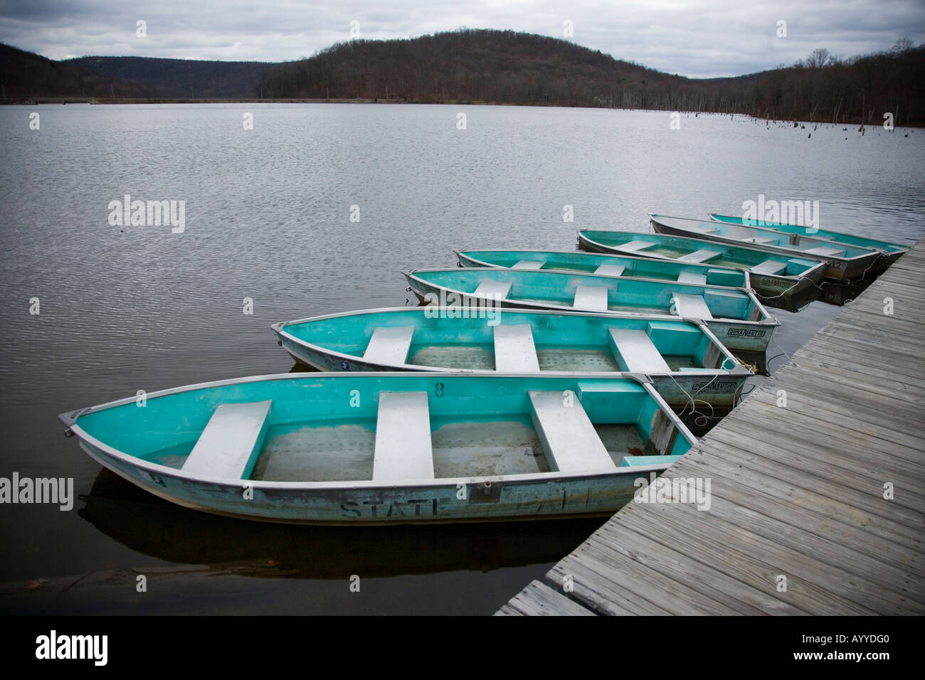 Rowboats docked by a lake Stock Photo - Alamy