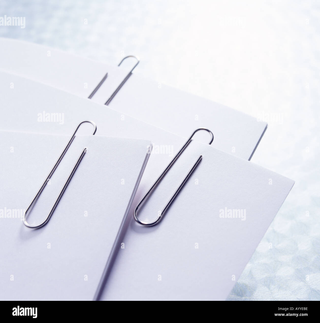 Three paperclip on the edge of a bunch of documents holding clear blank ...