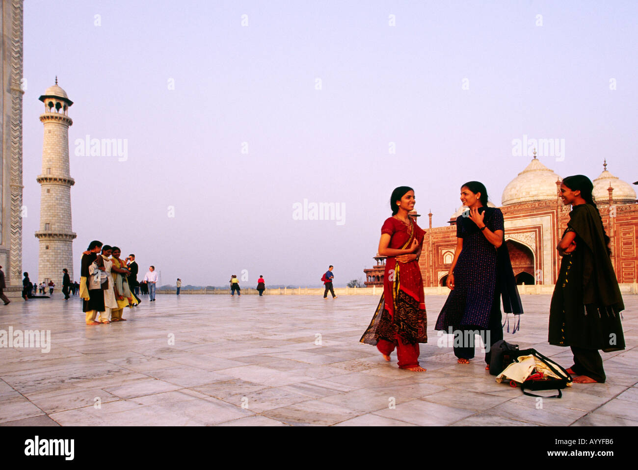 Three Indian women wearing traditional clothes sari standing at the ...
