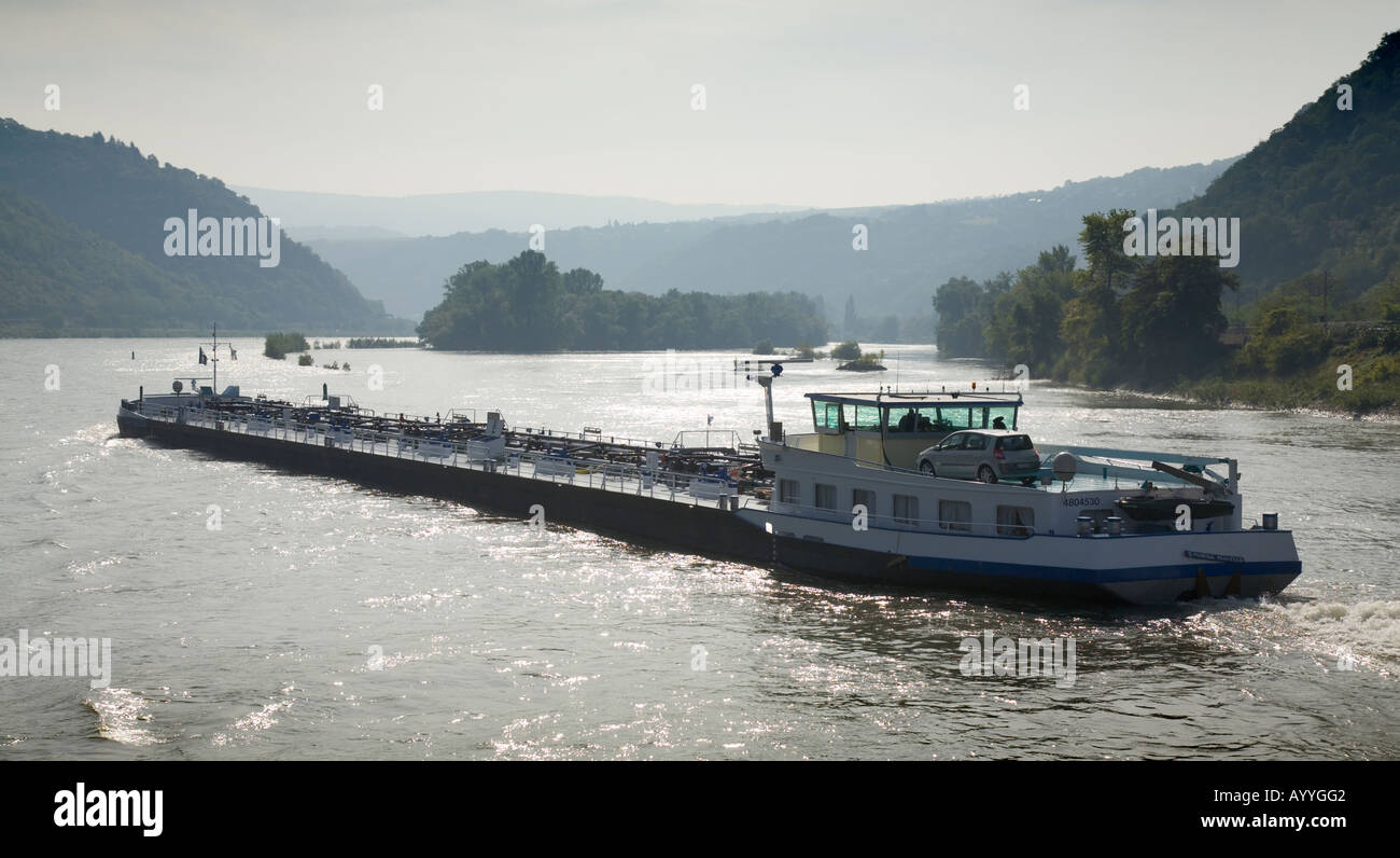 A cargo ship driving on the river Rhine in the German Middle-Rhine ...