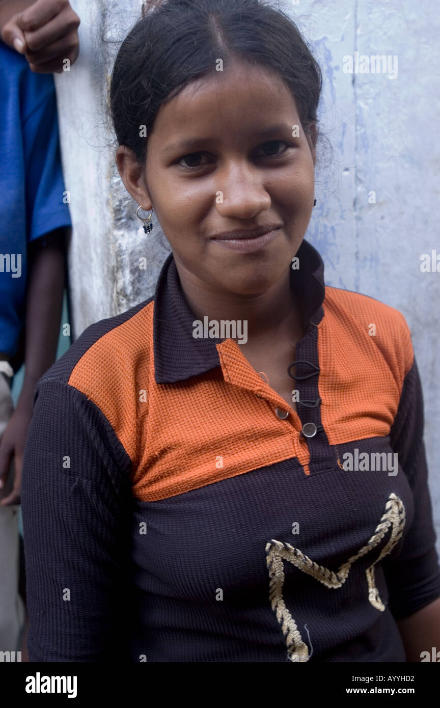 Young pretty Indian girl in modern dress looking at camera and smiling ...