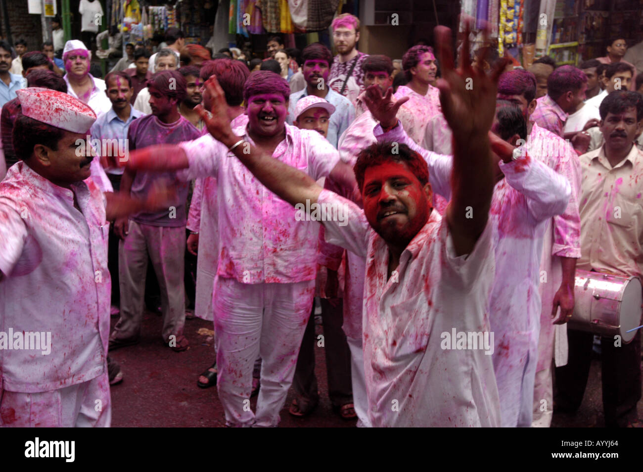 Group of Indian man dancing on the street of New Delhi during Holi ...