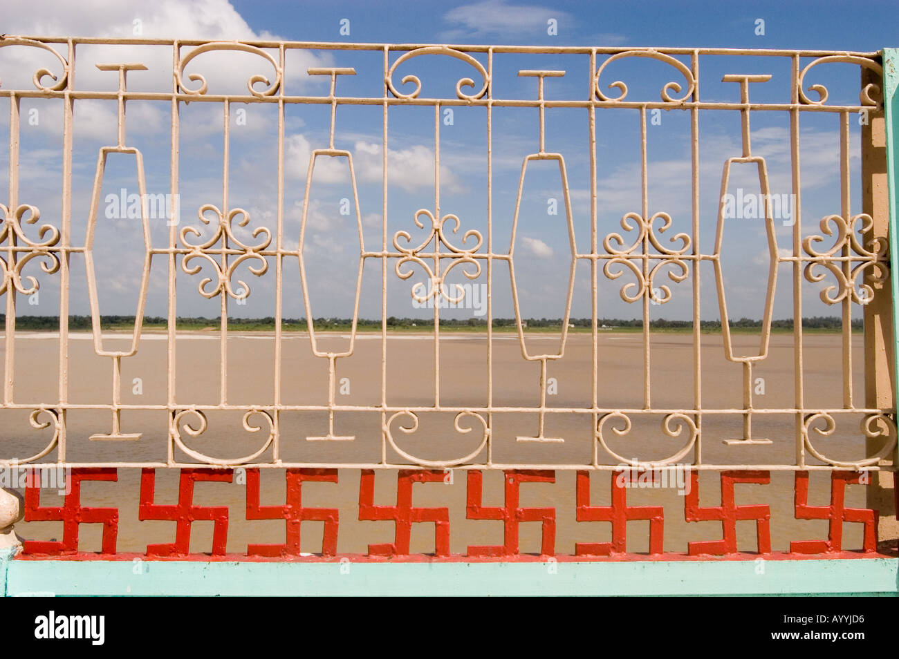 Metal white and red balustrade with row of swastikas and view of Ganges ...