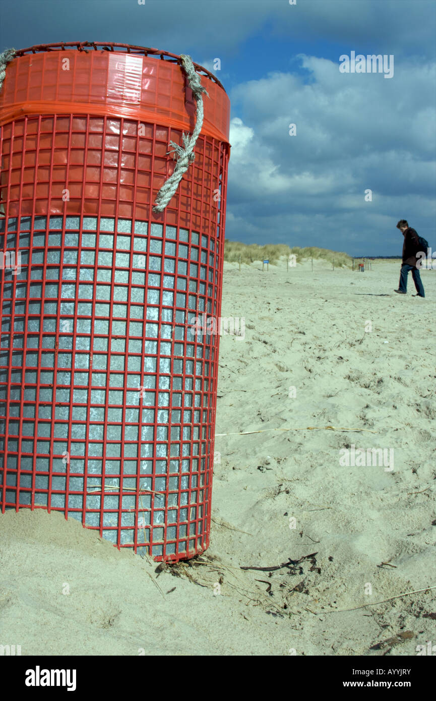 A recycling bin, a beach and a beachcomber at Studland Beach, Dorset ...