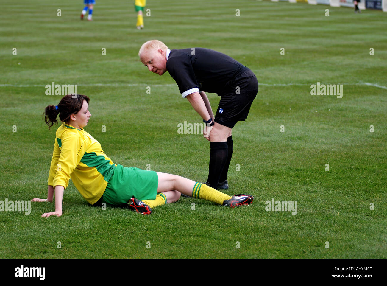 Referee attending women`s football player on ground, UK Stock Photo - Alamy