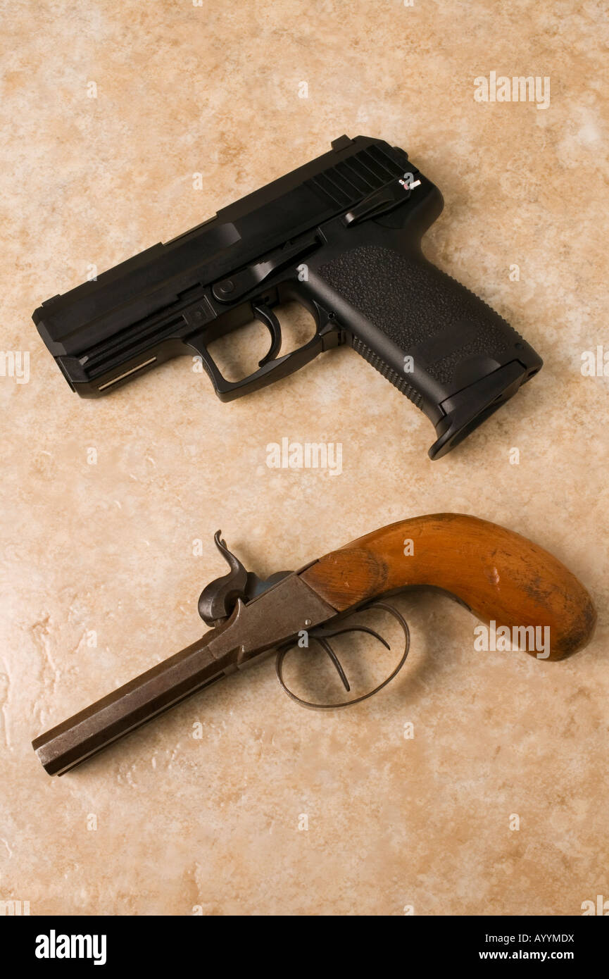 Two pistols one old one new Stock Photo - Alamy