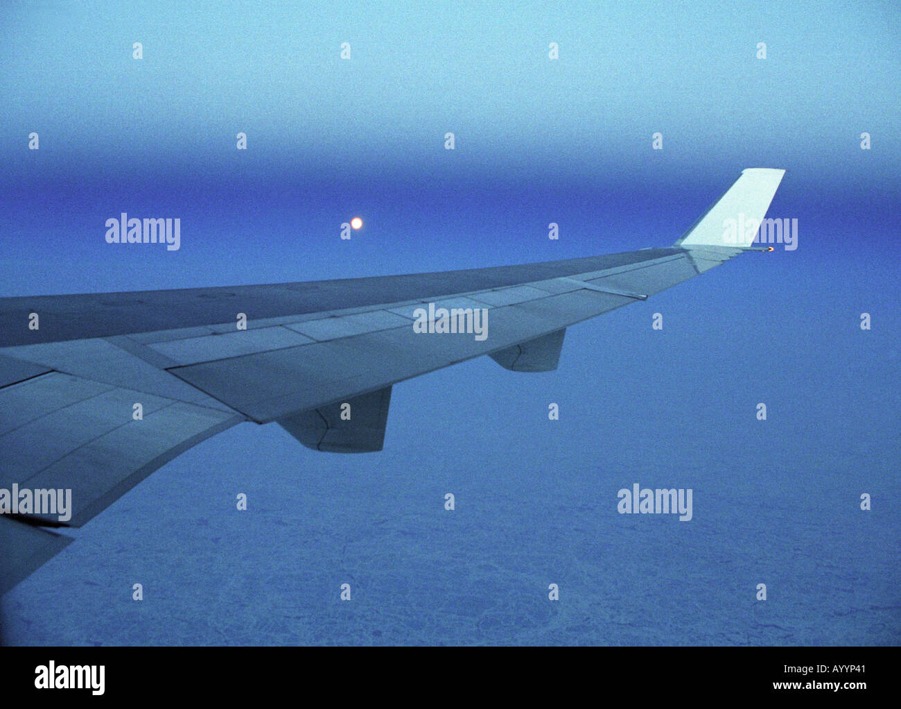 Wing and moon viewed through the window of a jet airliner Stock Photo ...