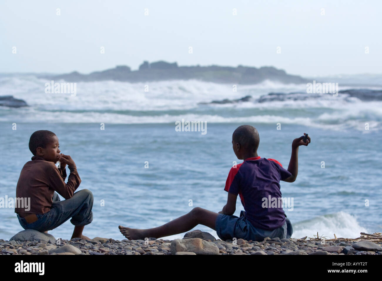 Some African children through pebbles into the sea, Transkei coast ...