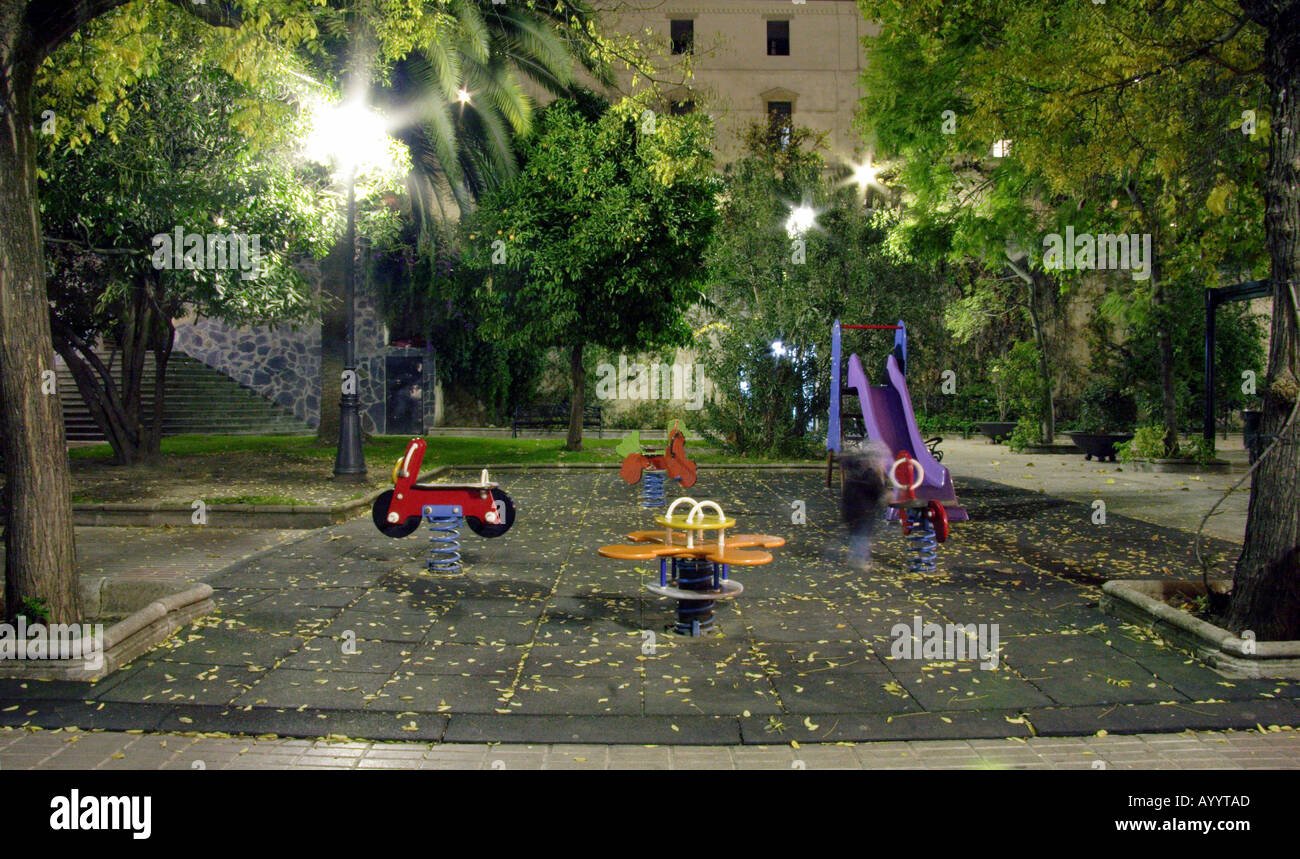 Night shot of a child playing in a playground Stock Photo - Alamy