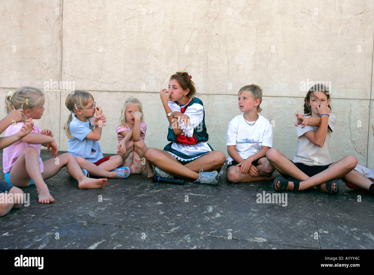 Group of children playing with supervisor children boy girl infant sand ...