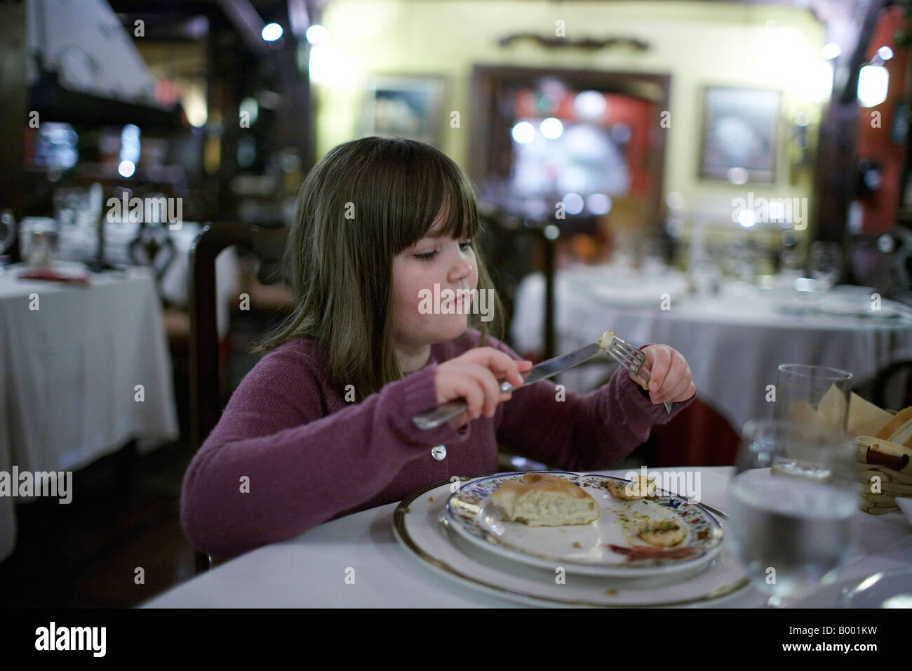 Young girl eating in nice restaurant Stock Photo - Alamy