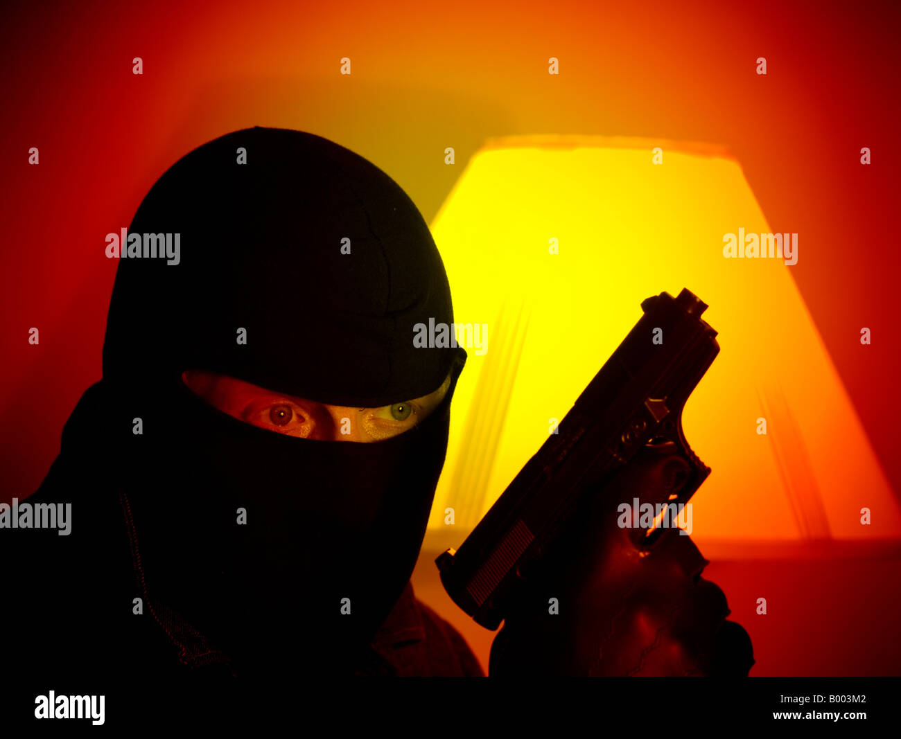 terrorist wearing a ski mask and holding hand gun Stock Photo - Alamy