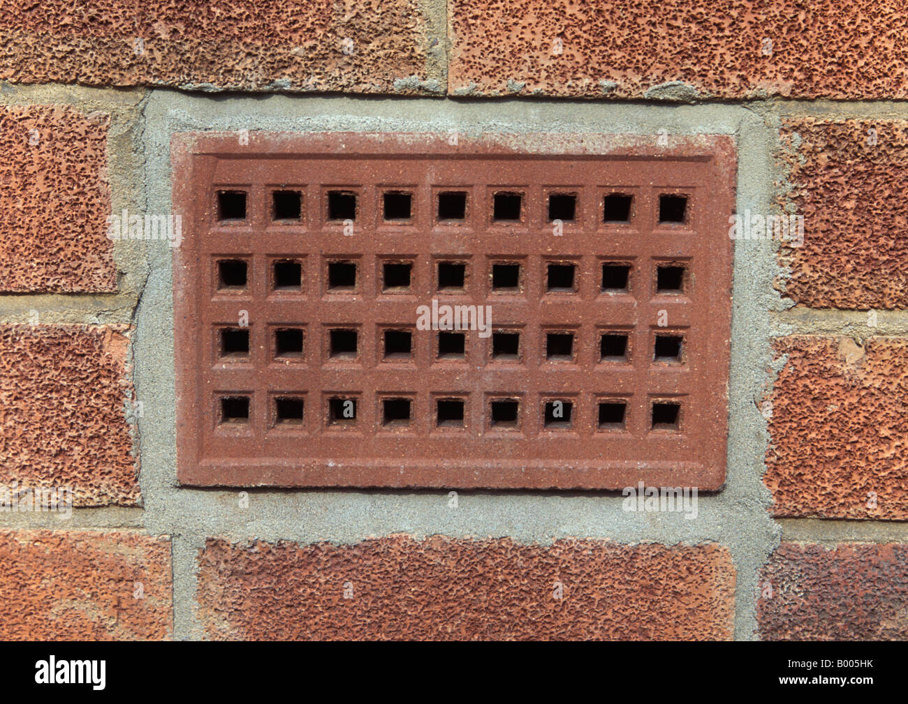 Terracotta air brick in red brick wall Stock Photo - Alamy