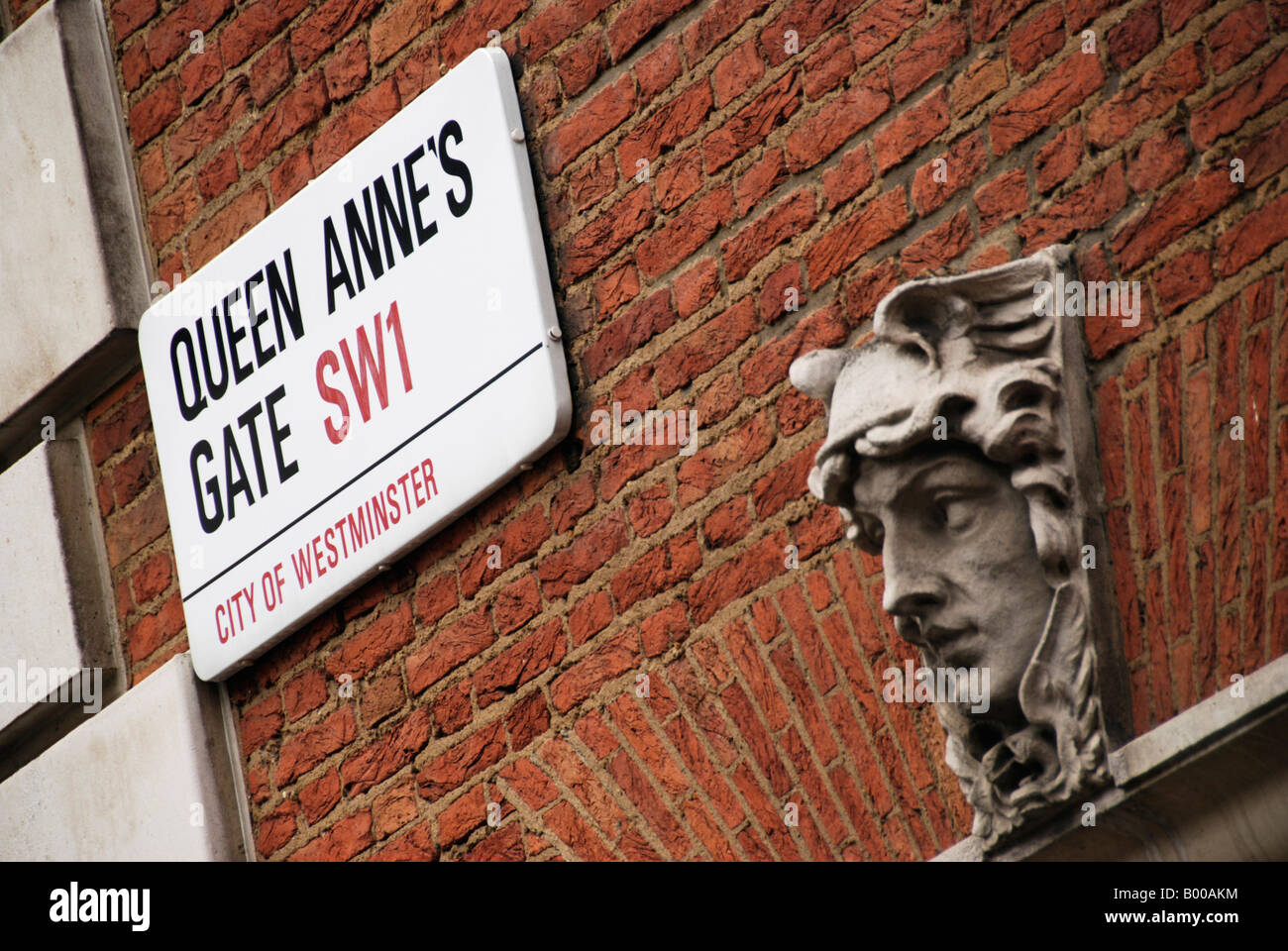 Queen Anne's Gate street sign and stone head London England Stock Photo ...