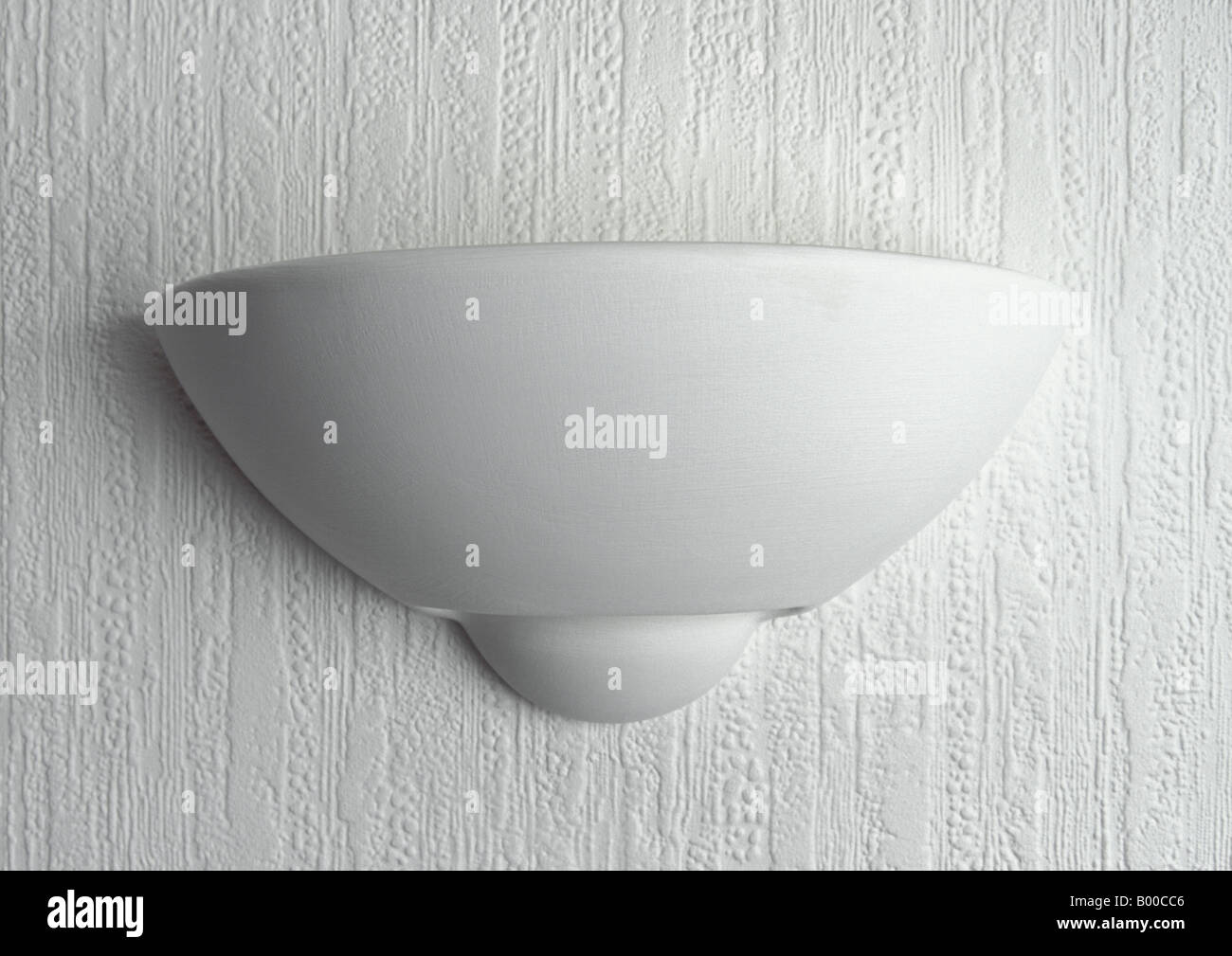 White ceramic uplighter on white wall Stock Photo - Alamy