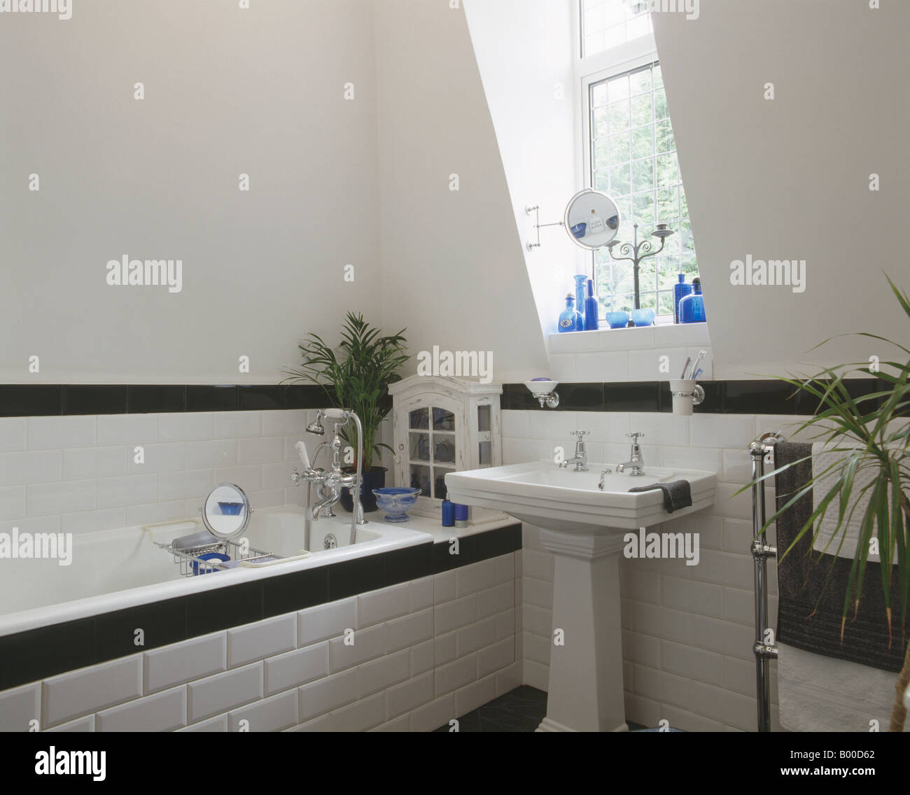 Black tiled dado and matching tiled bath edging in modern white ...