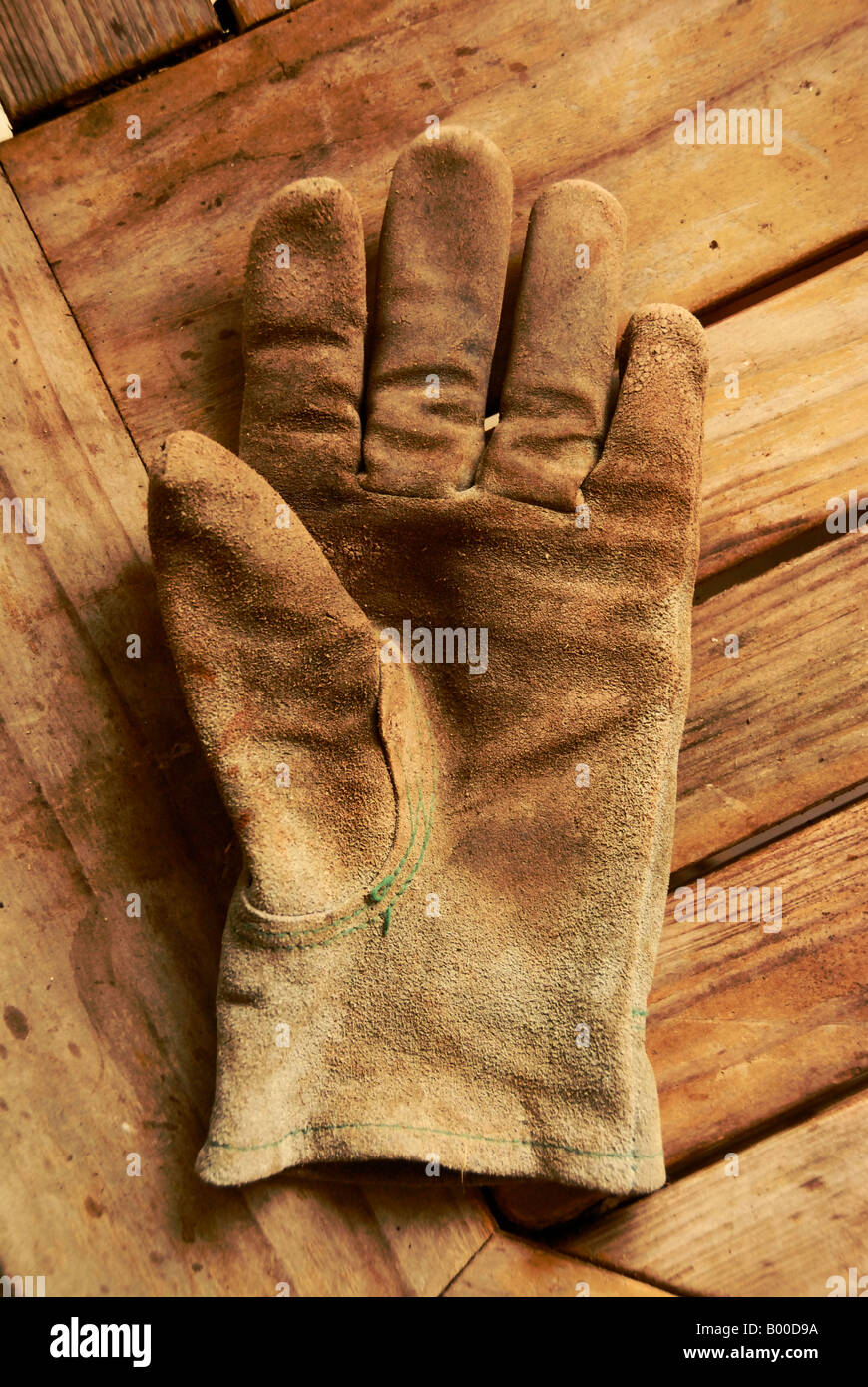 single old work glove on table Stock Photo - Alamy