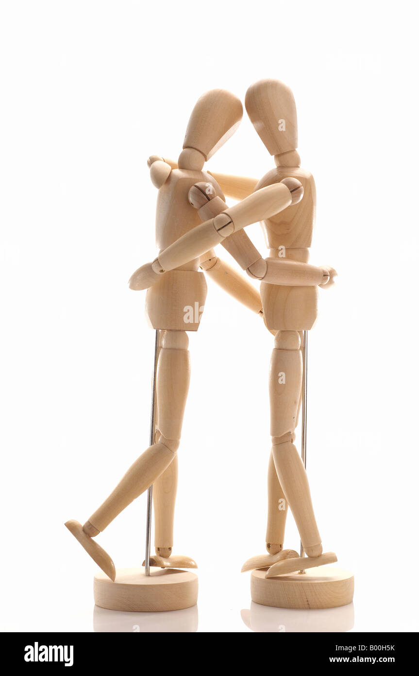Carved wooden figures hugging Stock Photo - Alamy