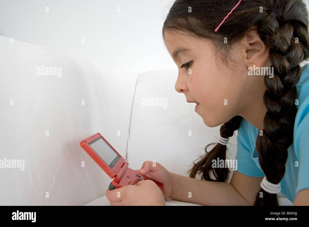 Little girl with a game boy Stock Photo - Alamy
