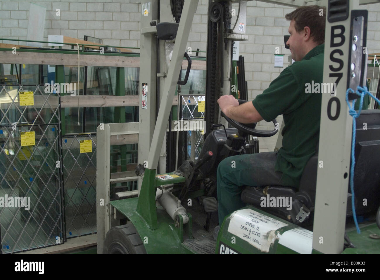 Forklift driver moving glass panel in glass factory Stock Photo - Alamy
