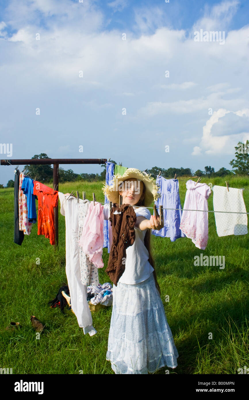 Young lady hanging clothes out on the line to dry in the summer Stock ...
