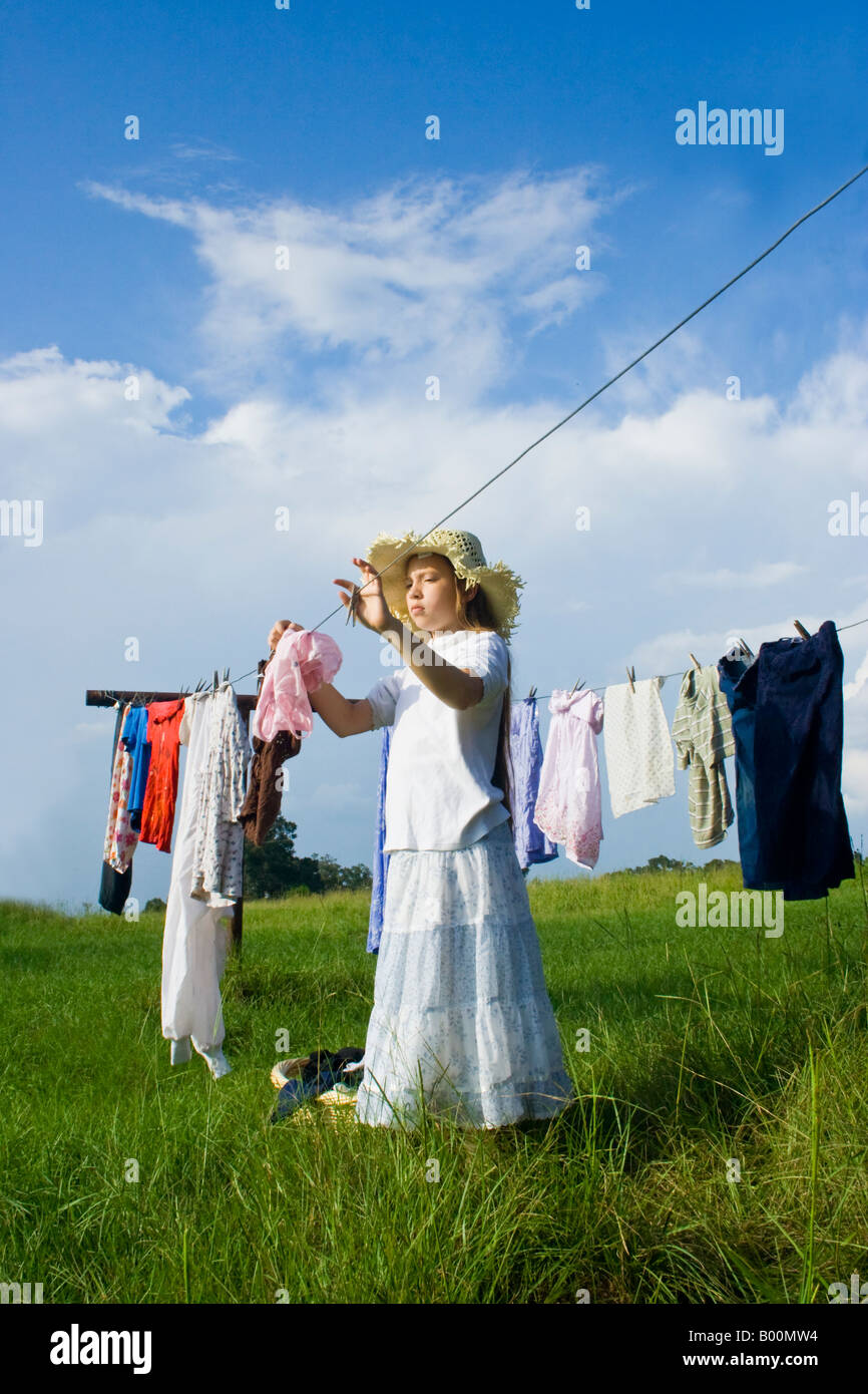 Young lady hanging clothes out on the line to dry in the summer Stock ...