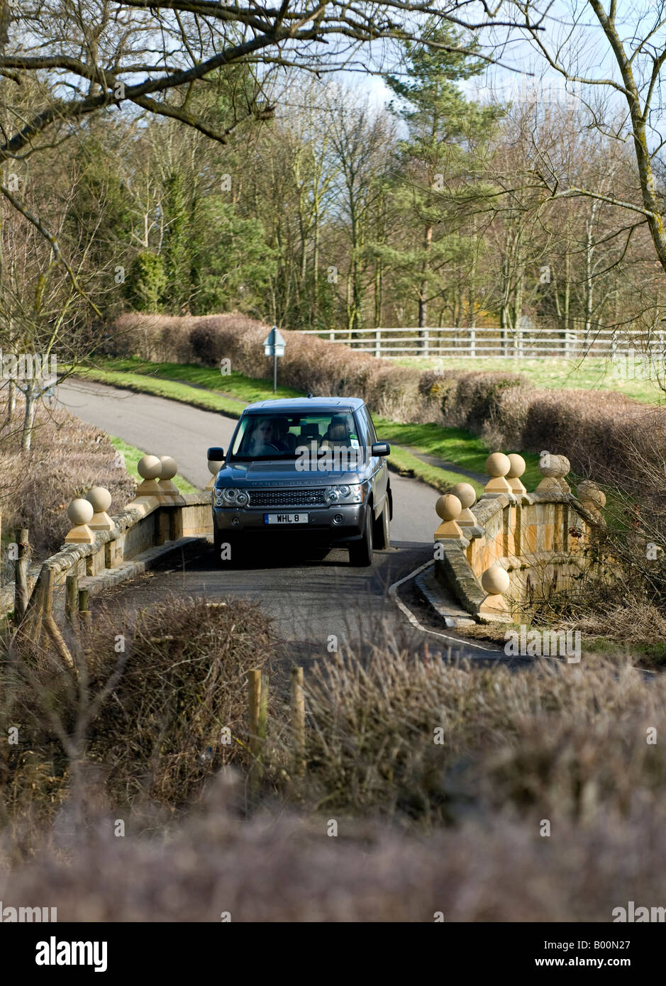 A Landrover Range Rover crosses the bridge over the River Stour at ...