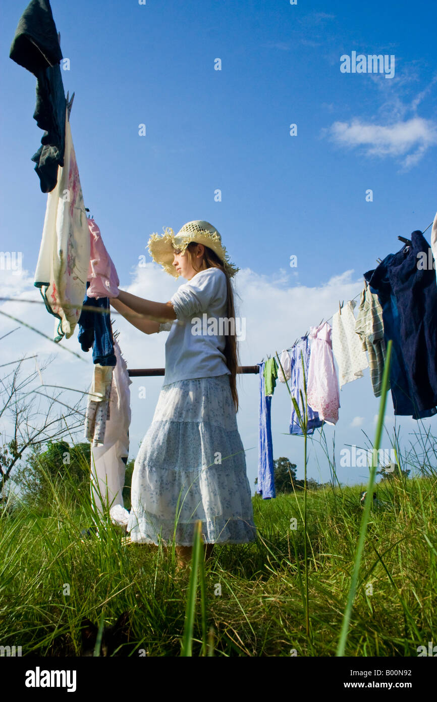 Young lady hanging clothes out on the line to dry in the summer Stock ...