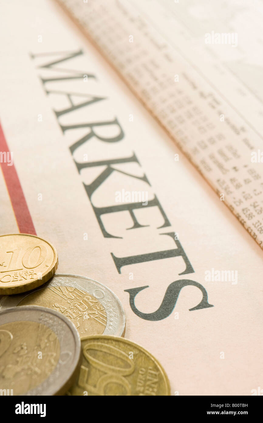 selection of euro coins on paper marked Markets Stock Photo - Alamy