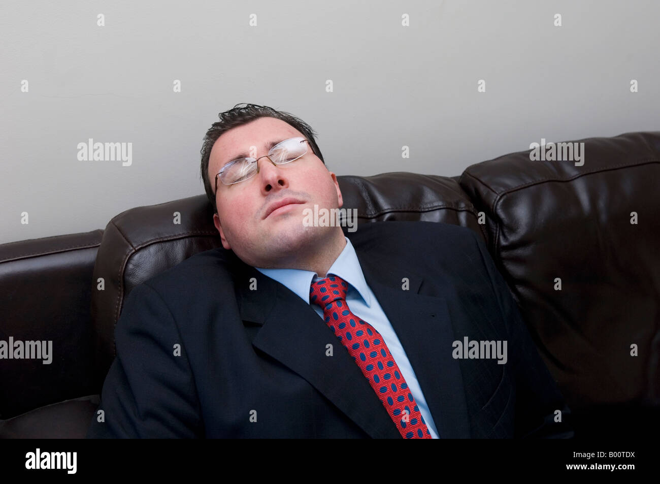 Business man sleeping on sofa Stock Photo - Alamy