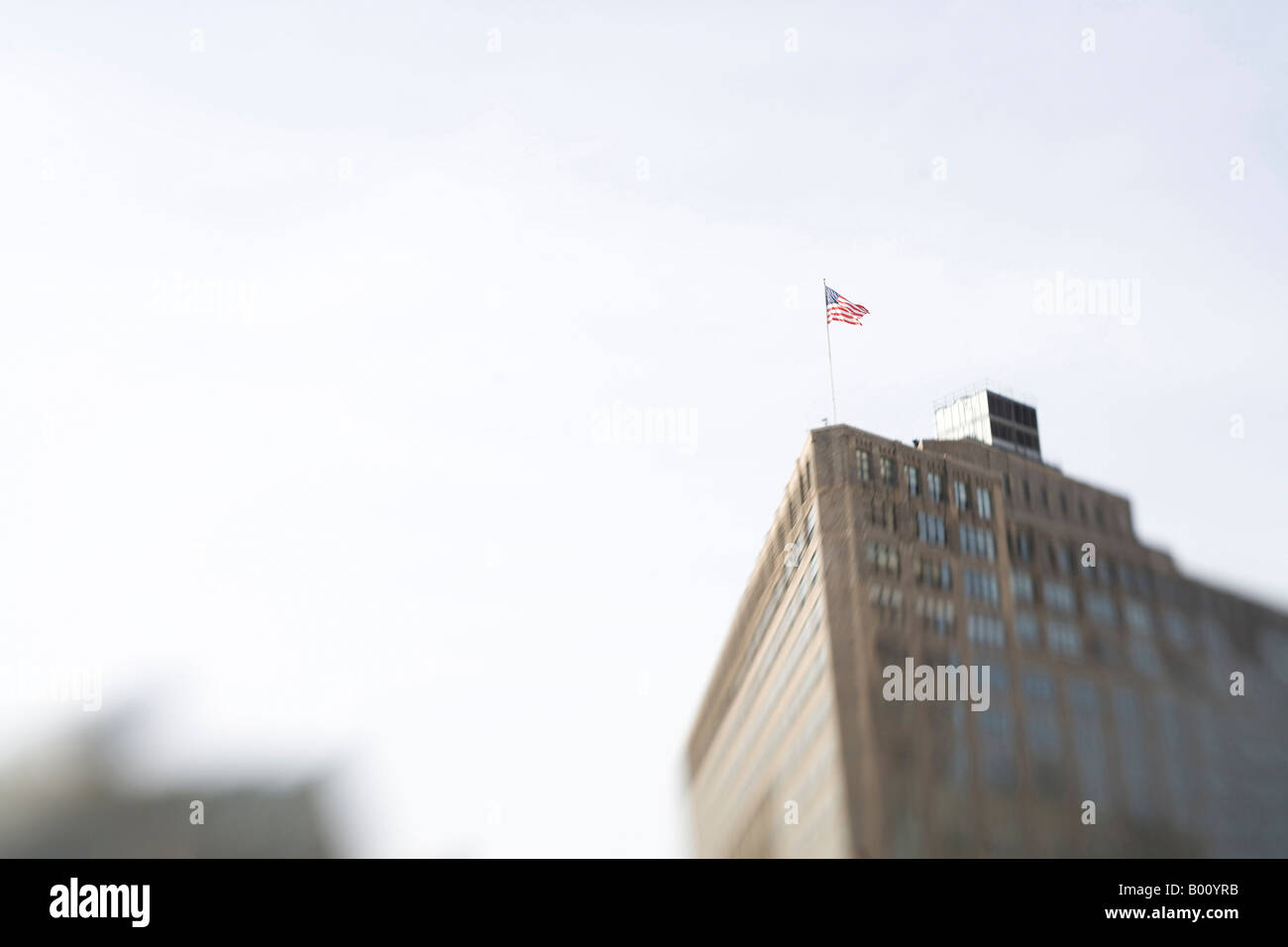 American flag flying on the corner of a rooftop as part of the ...