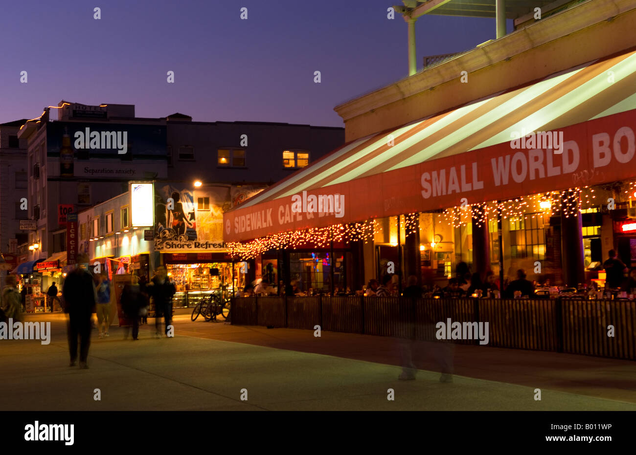 Sunset view of Venice Beach California at night showing shops and ...