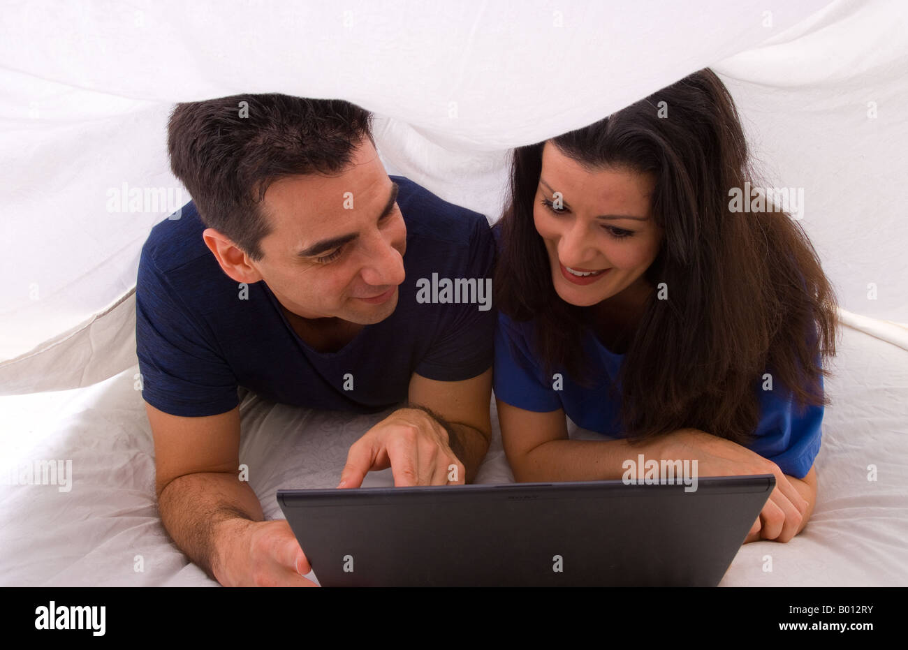 Couple under covers in bed hi-res stock photography and images - Alamy