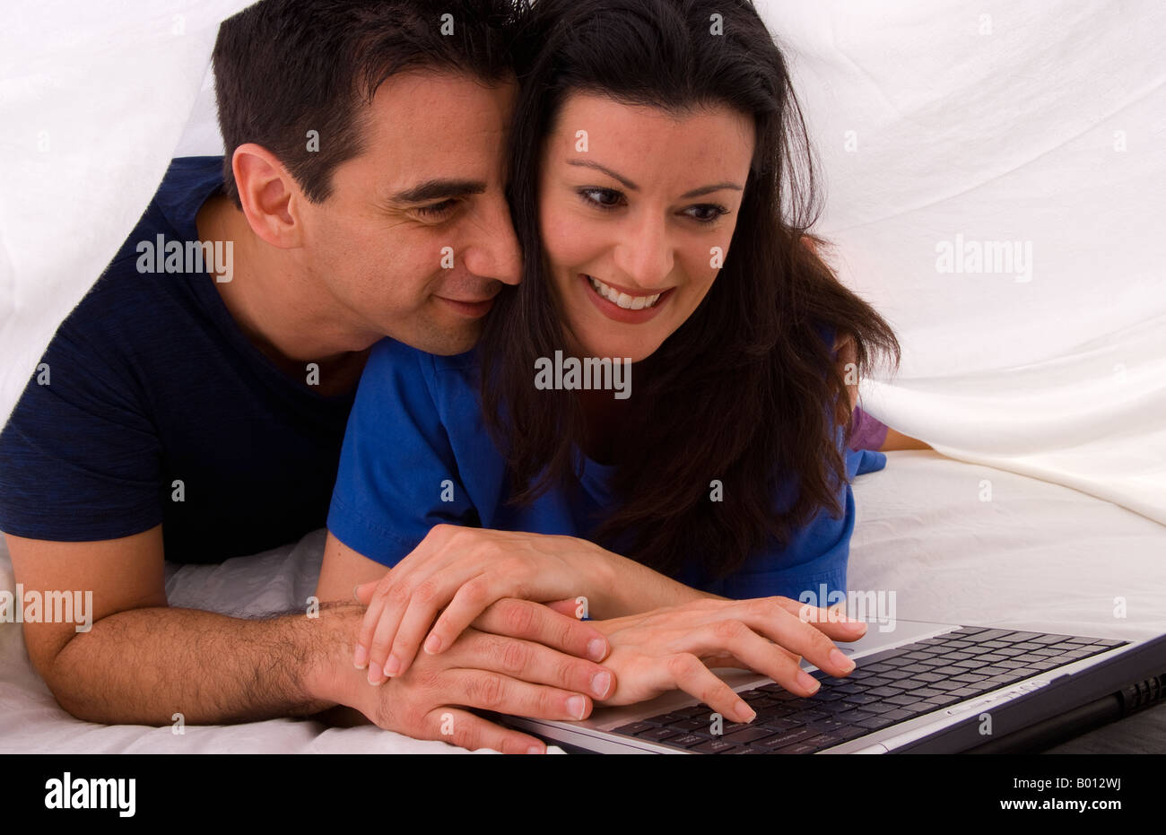 Couple under covers in bed hi-res stock photography and images - Alamy