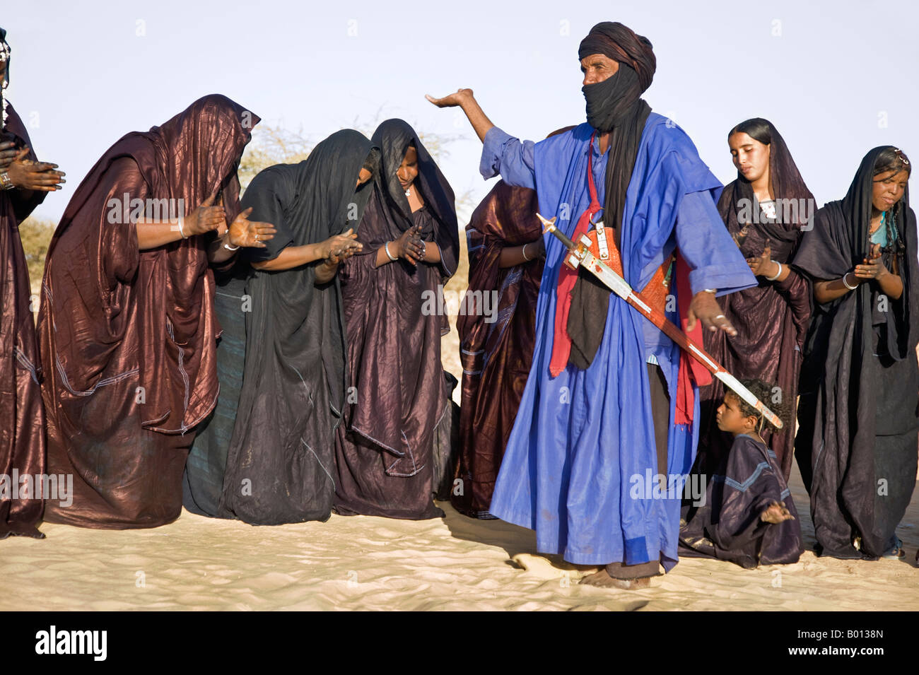 Mali, Timbuktu. A group of Tuareg men and women sing and dance near ...