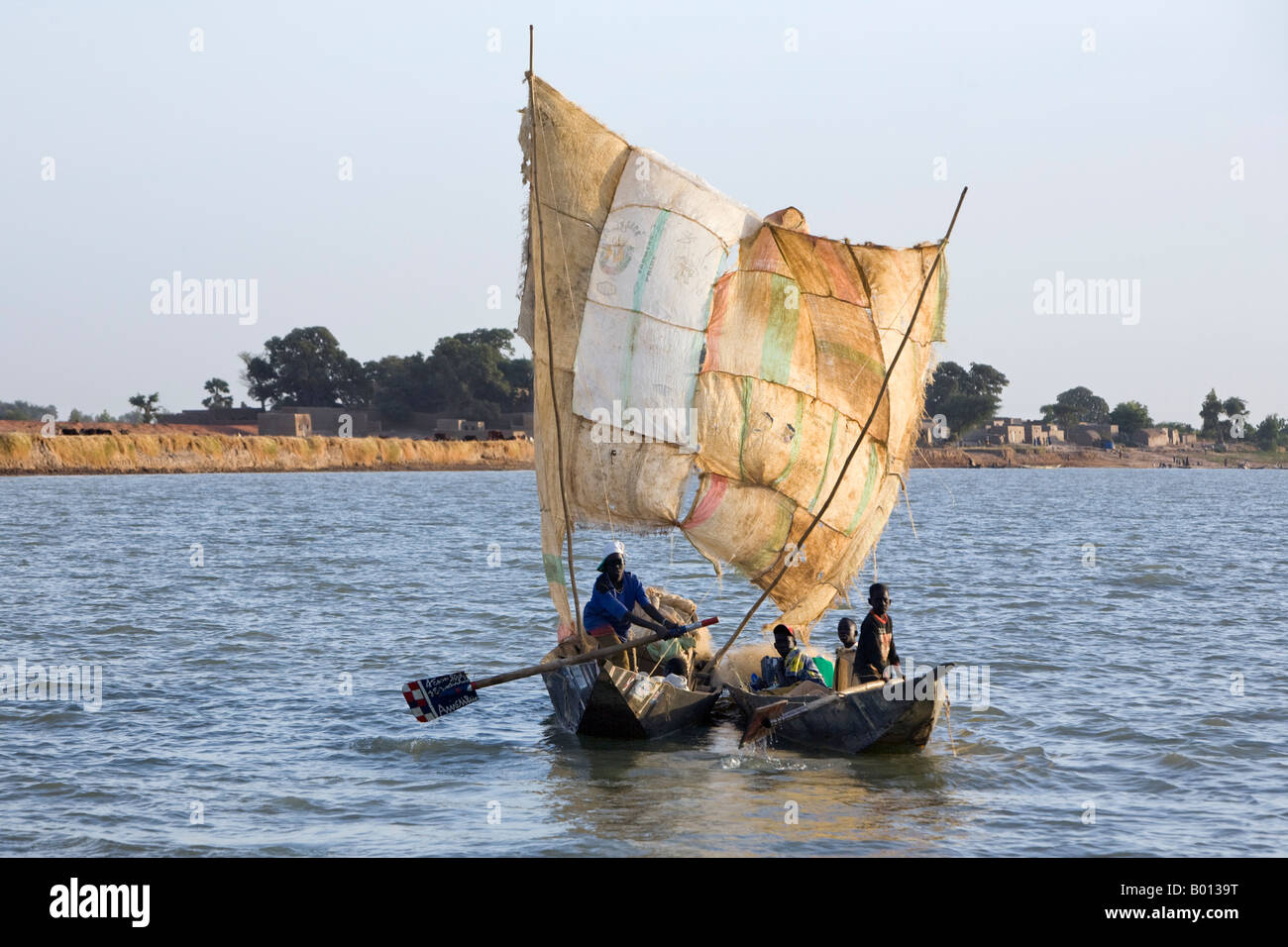 Mali, Niger Inland Delta. Two pirogues under one sail on the Niger ...